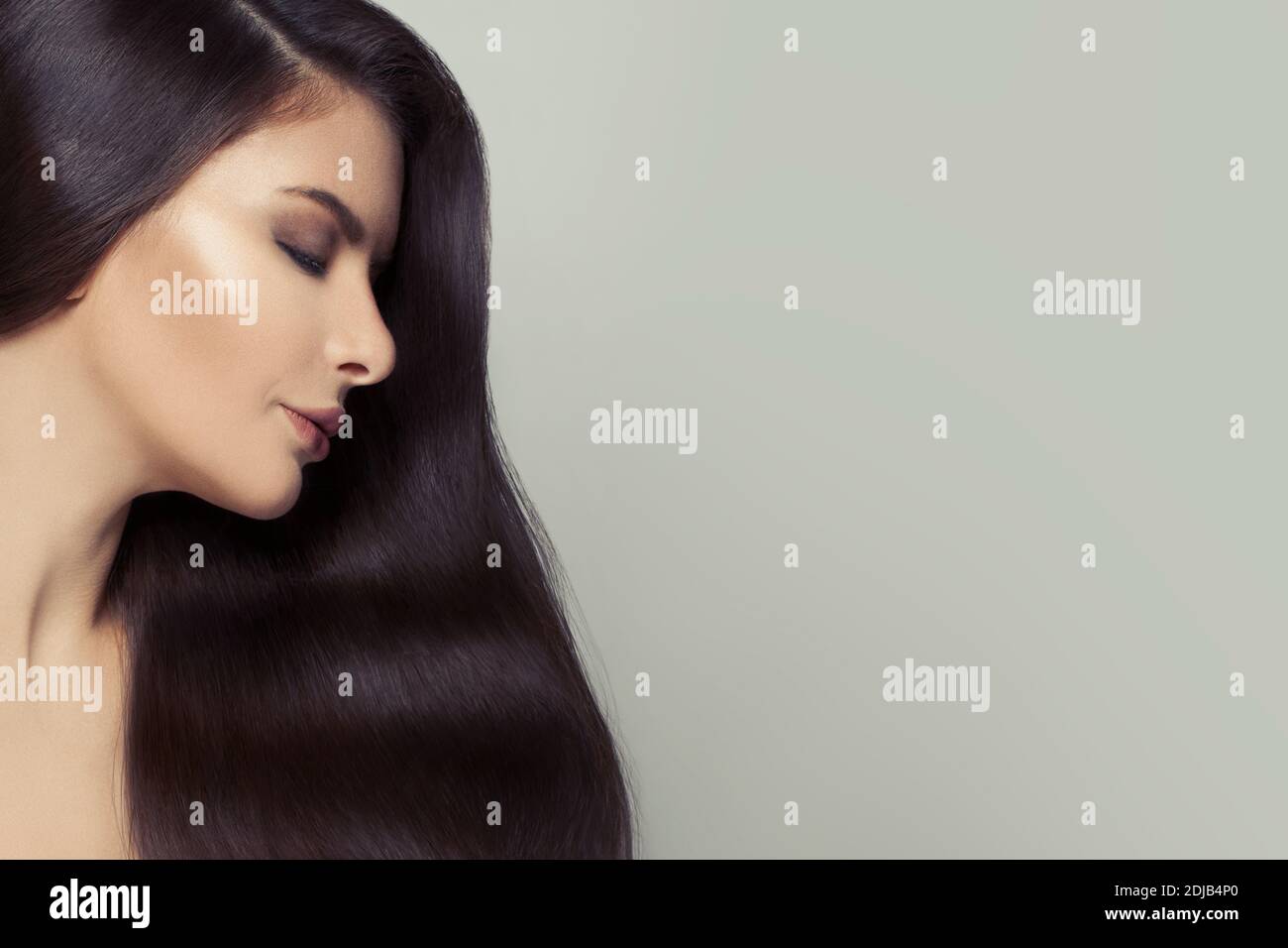 Beautiful woman with long healthy hairstyle on white background ...