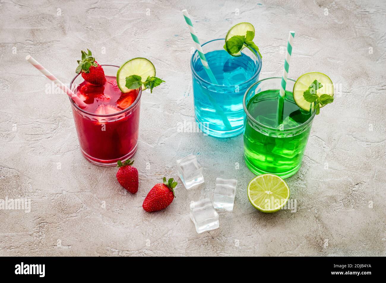Cold green, blue and red cocktails with fresh fruits and mint Stock ...