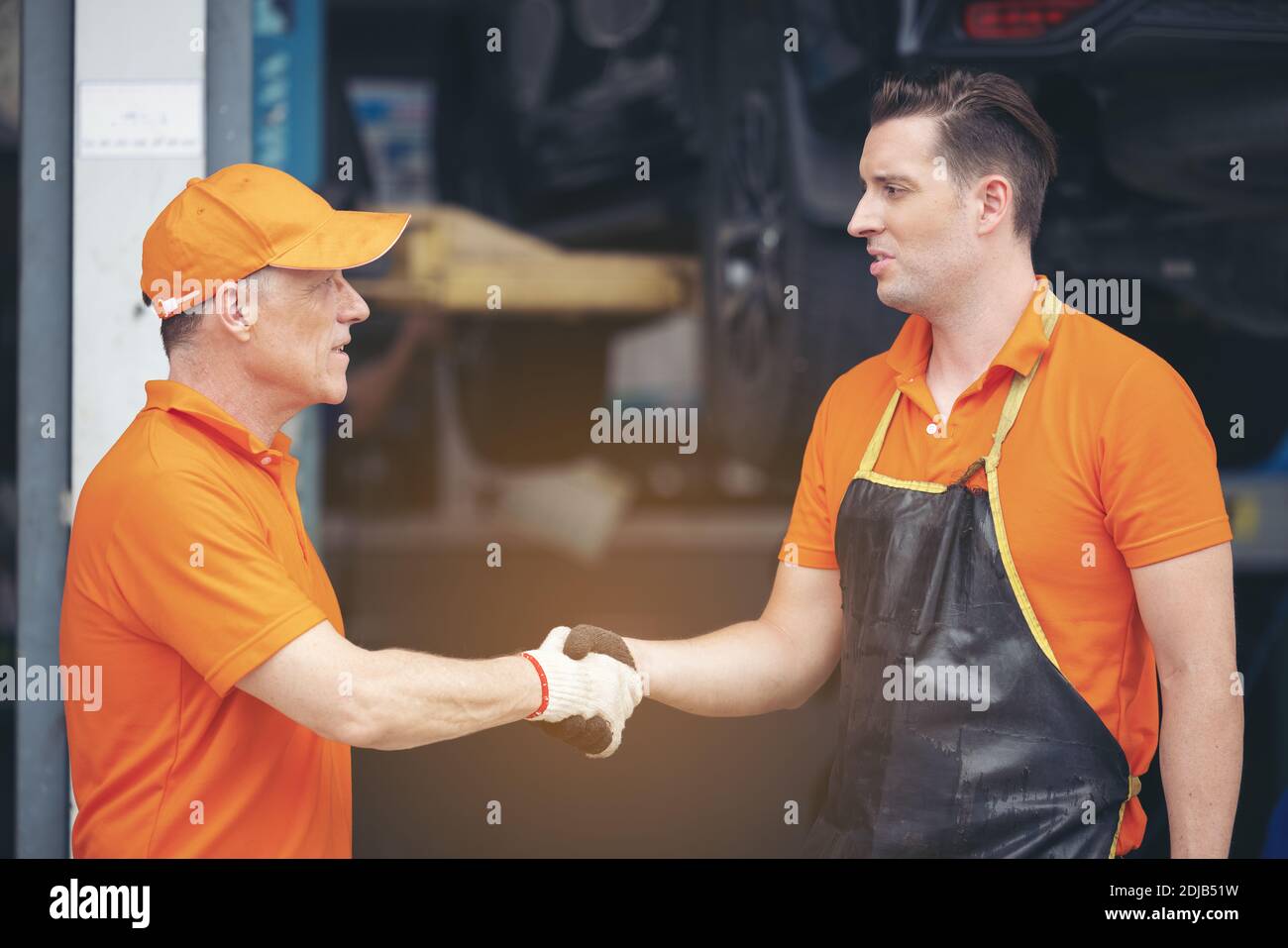 Professional mechanical employee of the car service handshake for agree ...