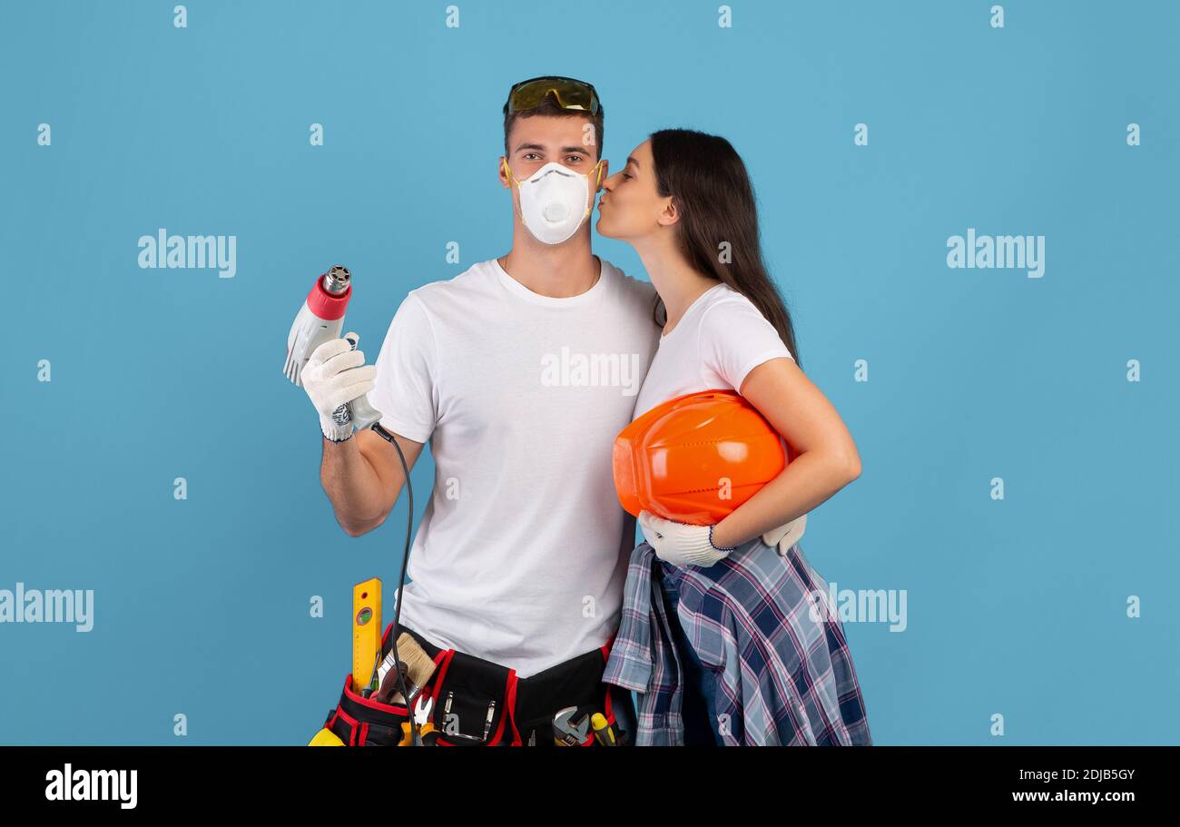 Loving couple doing repair together, posing with construction tools on ...
