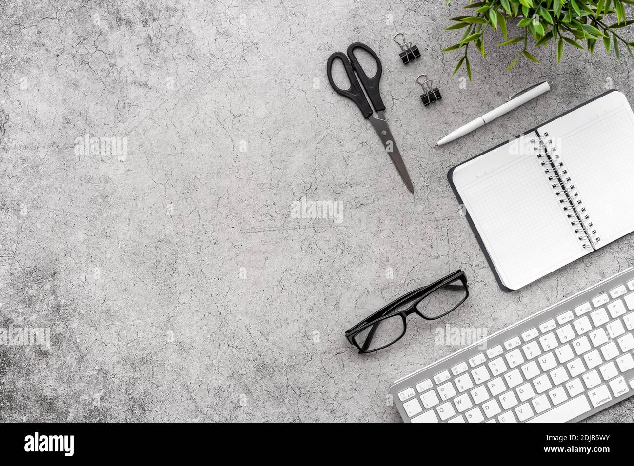 Flat lay office workspace with keyboard and office supplies, top view ...