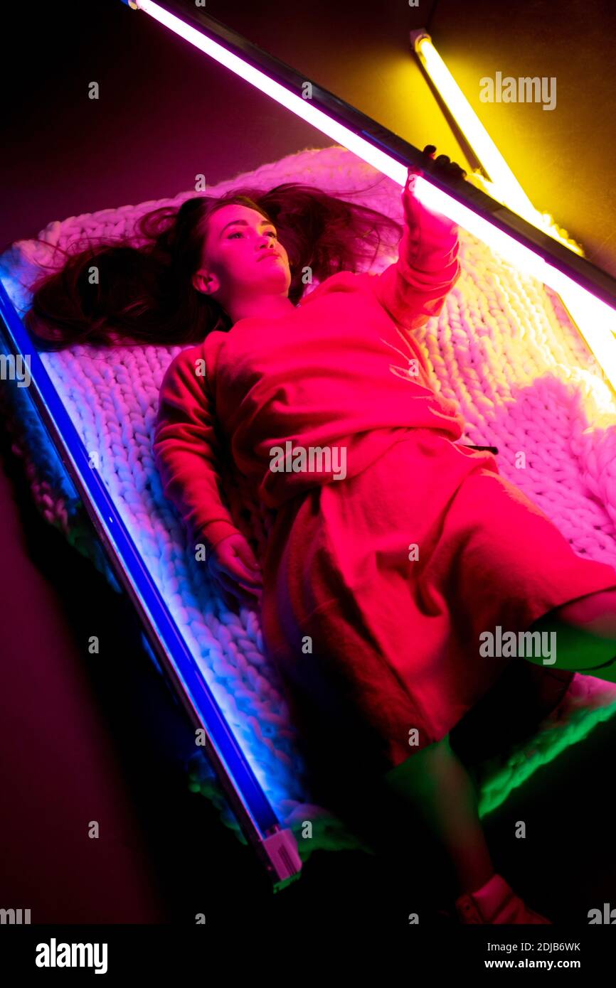 Urban. Caucasian female inclusive model posing on studio background in ...