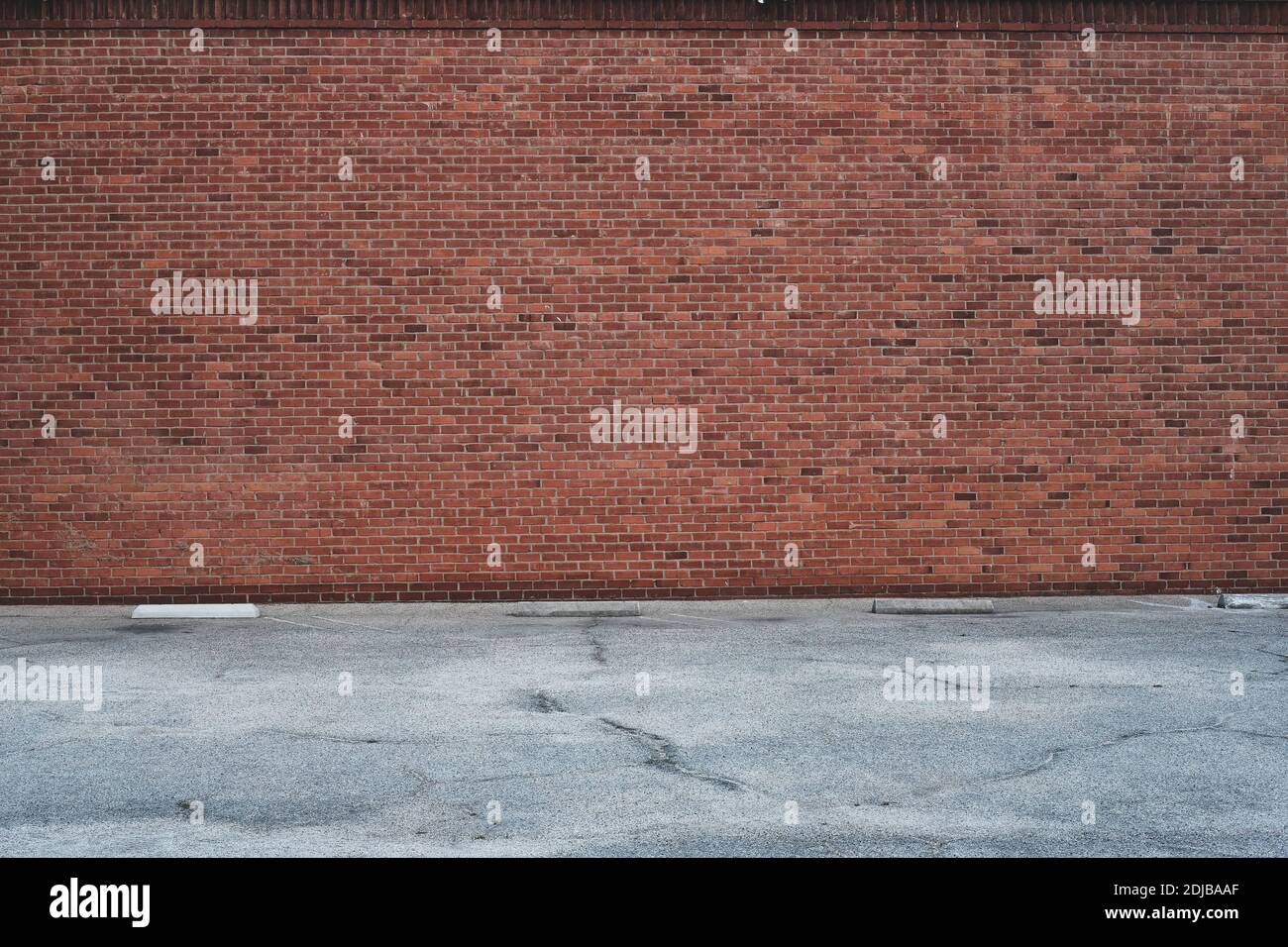 Road By Brick Wall Stock Photo - Alamy