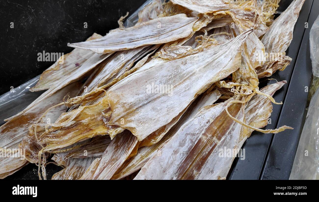 Dried cuttlefish on a food market stall for sale Stock Photo - Alamy