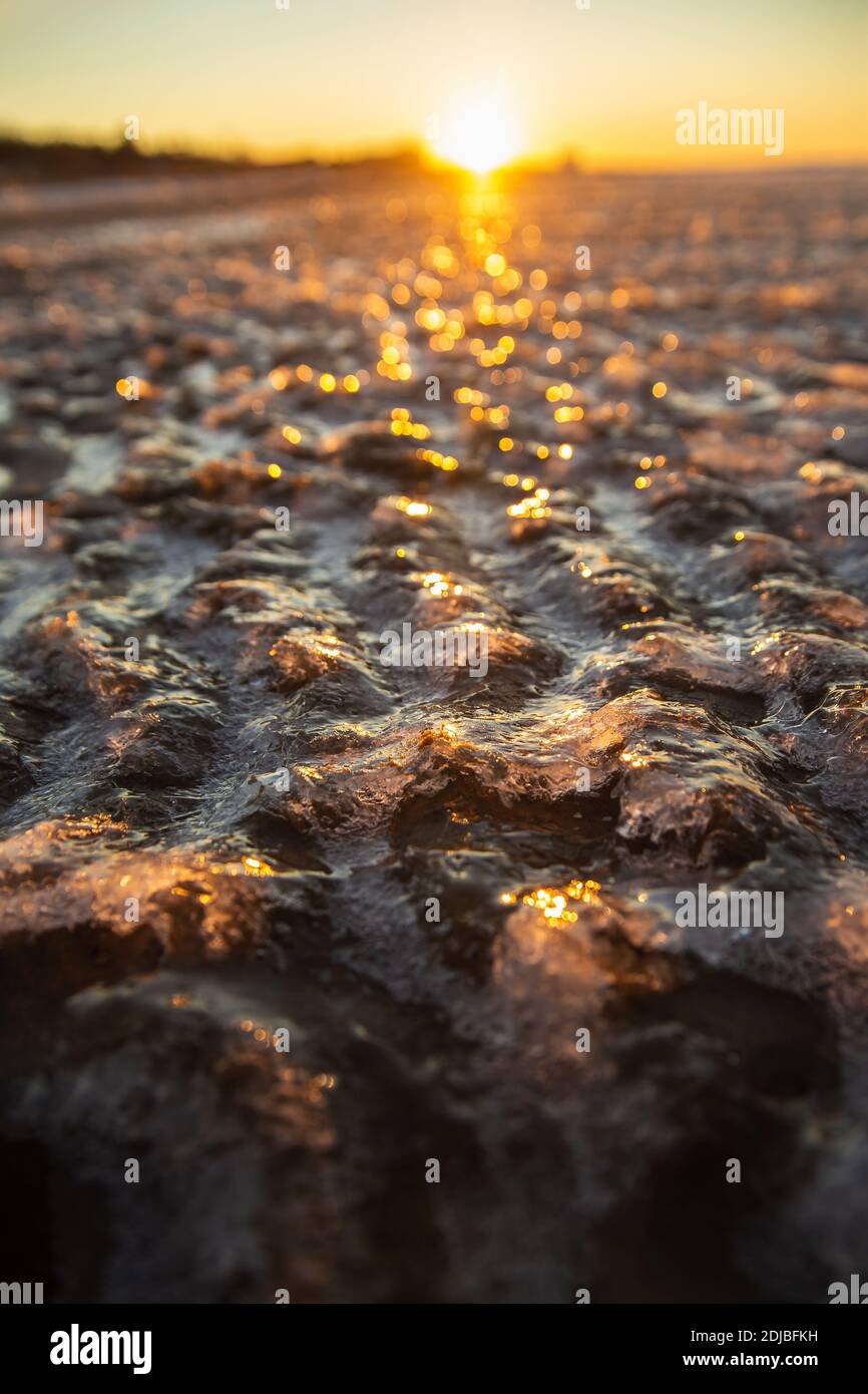 Frozen sea beach on the sinset. Ice covered sand waves Stock Photo - Alamy