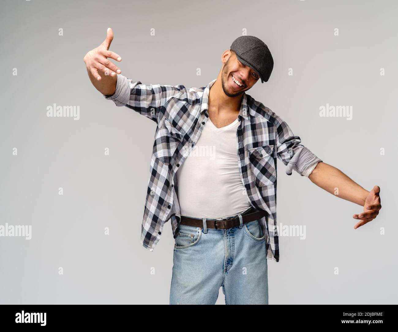 african american young handsome man over grey background looking at the ...