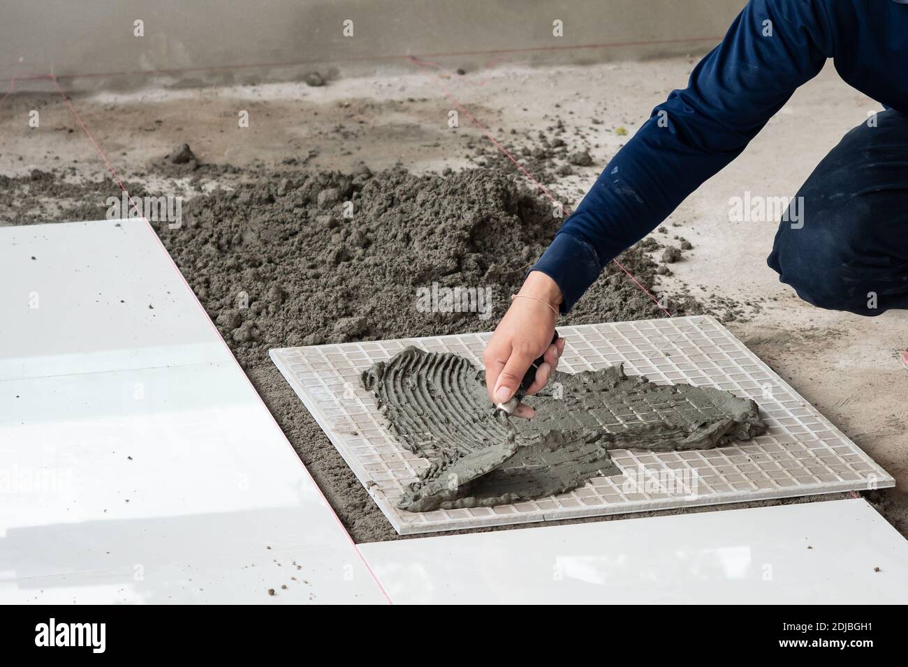 Man applying cement hi-res stock photography and images - Alamy