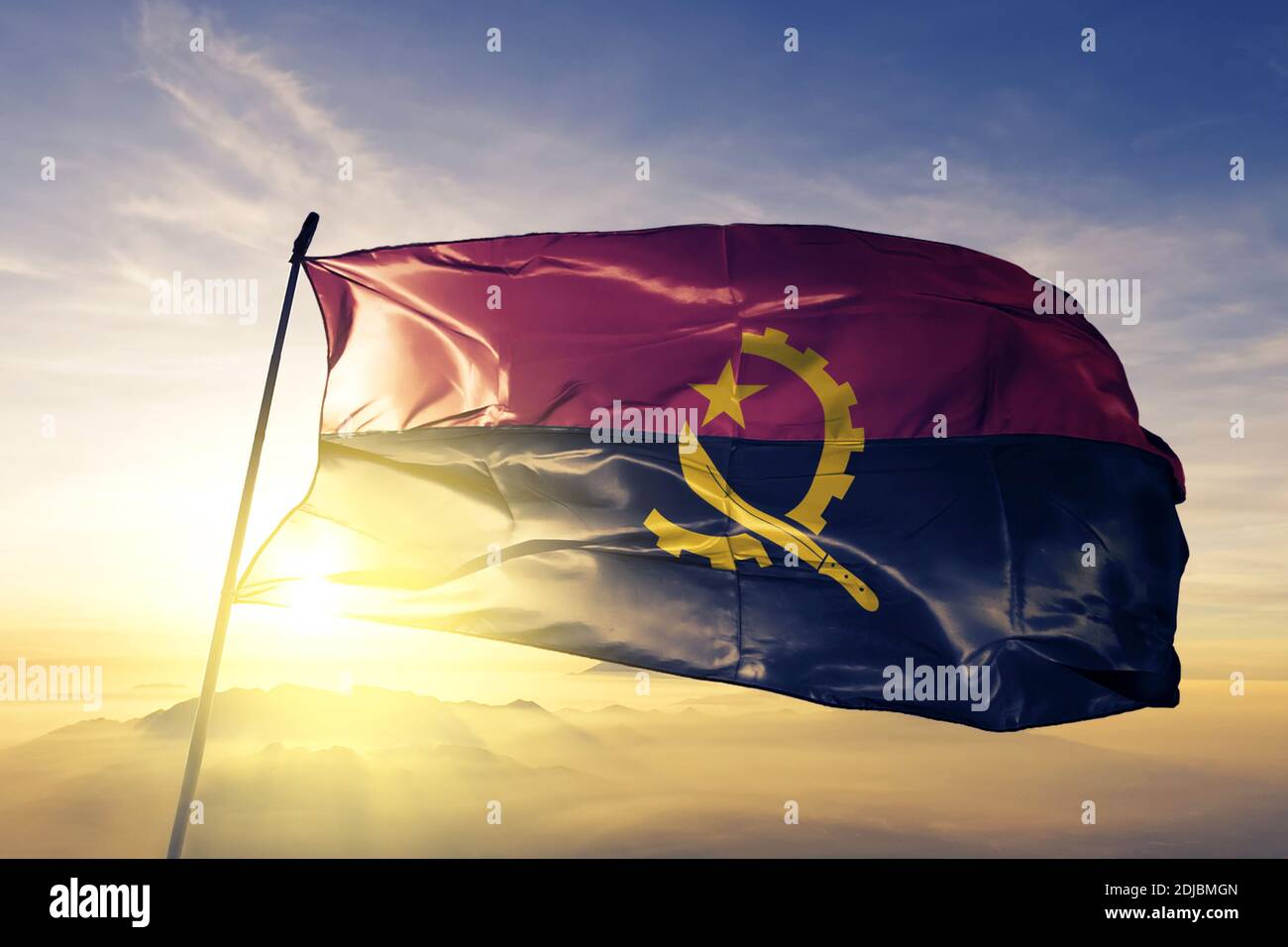 Angola flag waving on the top sunrise mist fog Stock Photo - Alamy