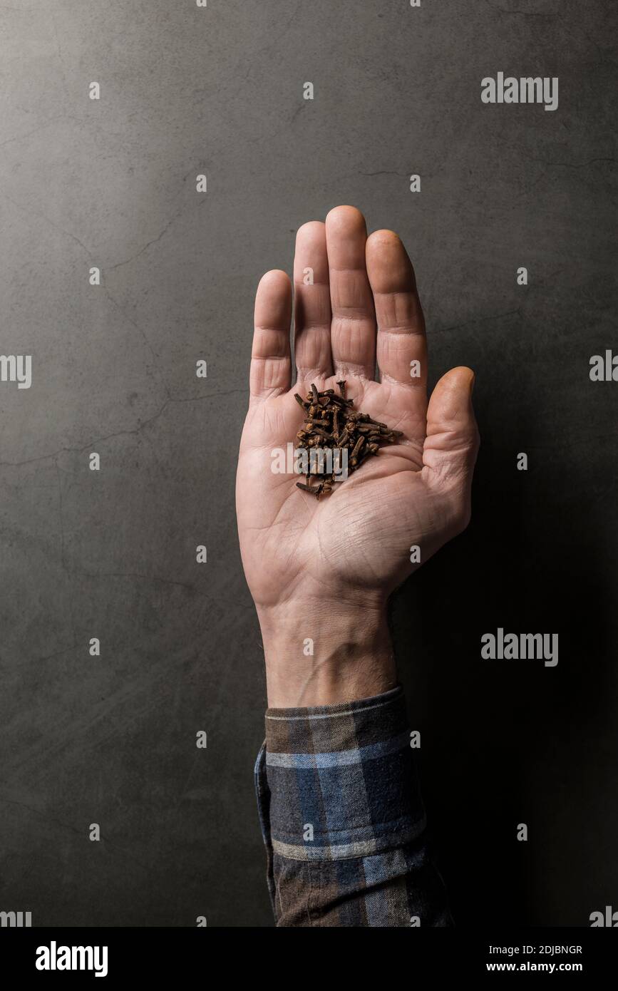 man's hand with cloves on grey stone background Stock Photo - Alamy