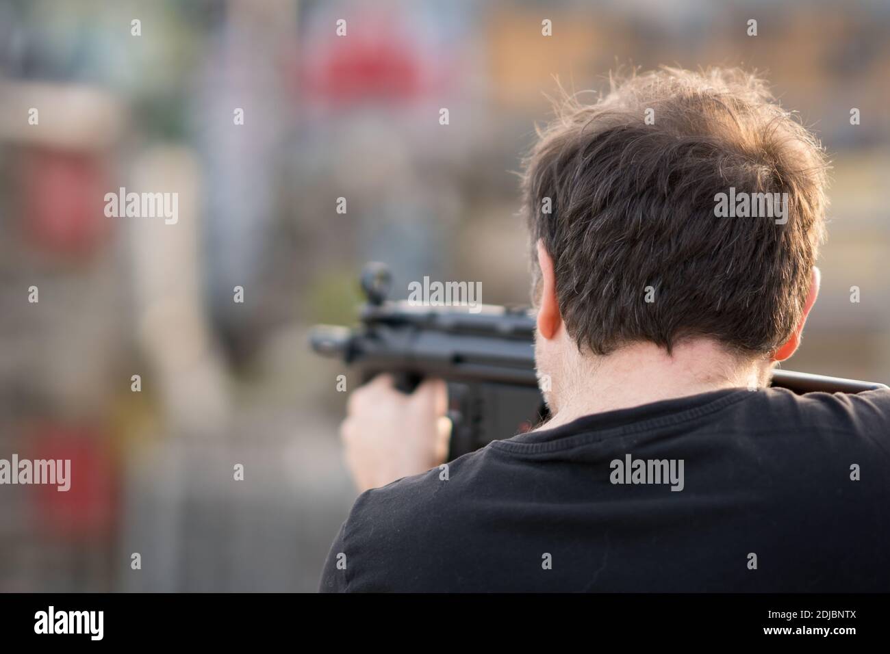 Man aiming handgun rear view hi-res stock photography and images - Alamy