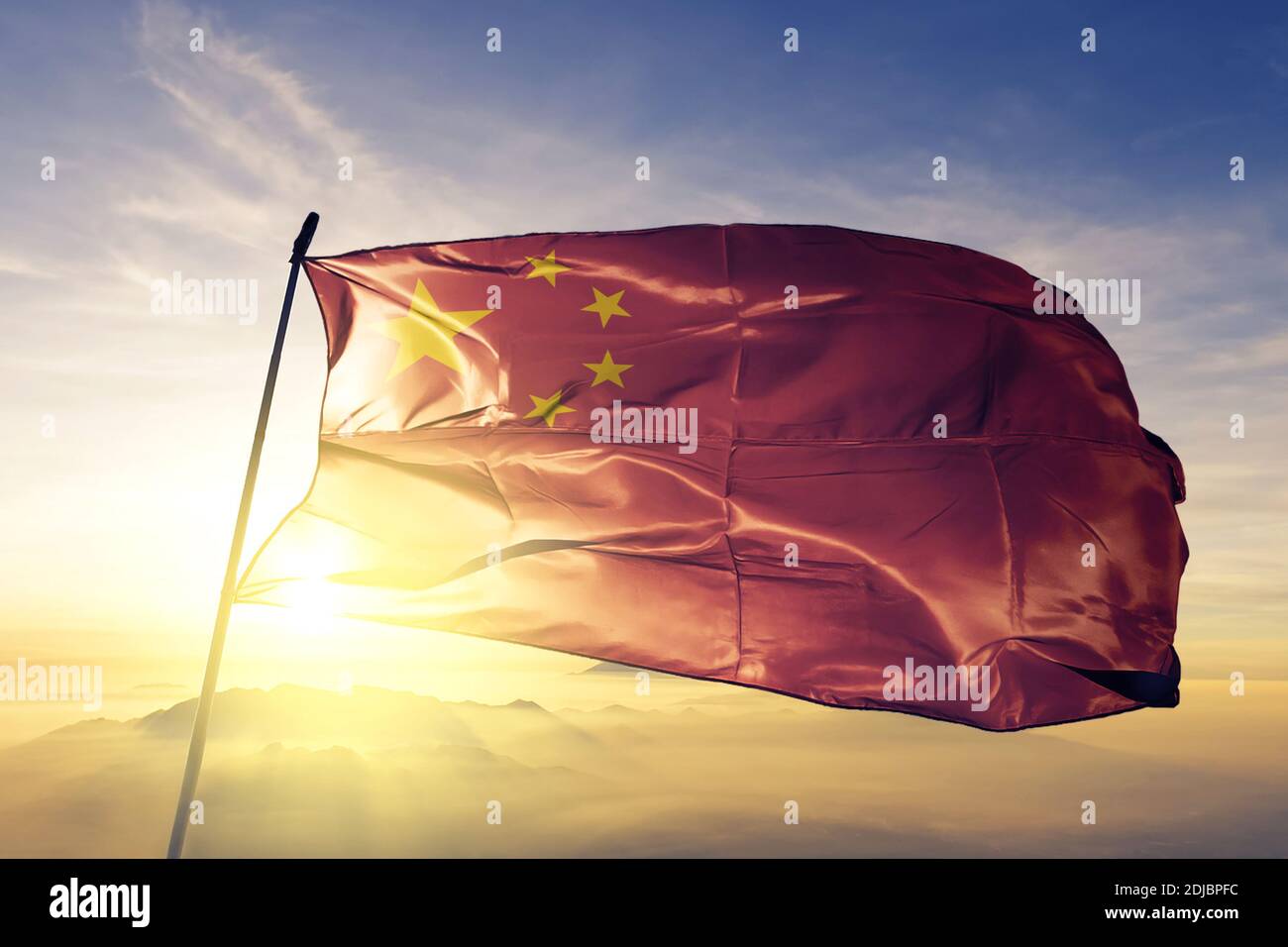 China flag waving on the top sunrise mist fog Stock Photo - Alamy