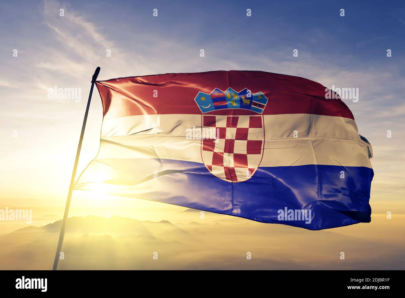 Croatia flag waving on the top sunrise mist fog Stock Photo - Alamy