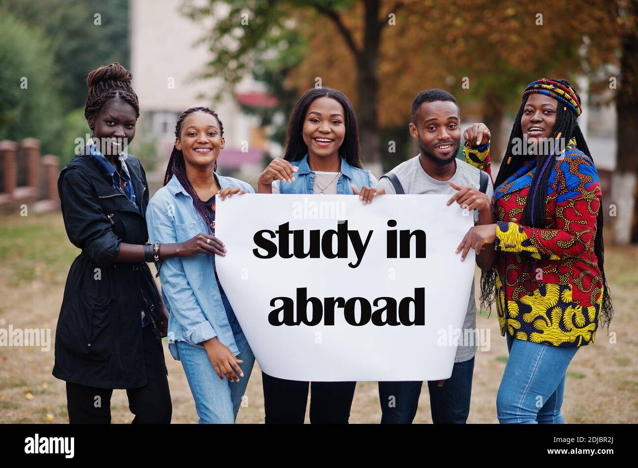 Group of five african college students on campus at university yard ...