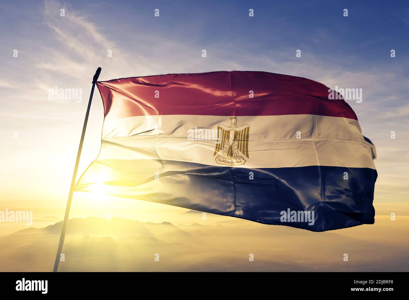 Egypt flag waving on the top sunrise mist fog Stock Photo - Alamy