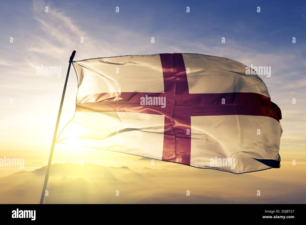 England flag waving on the top sunrise mist fog Stock Photo - Alamy