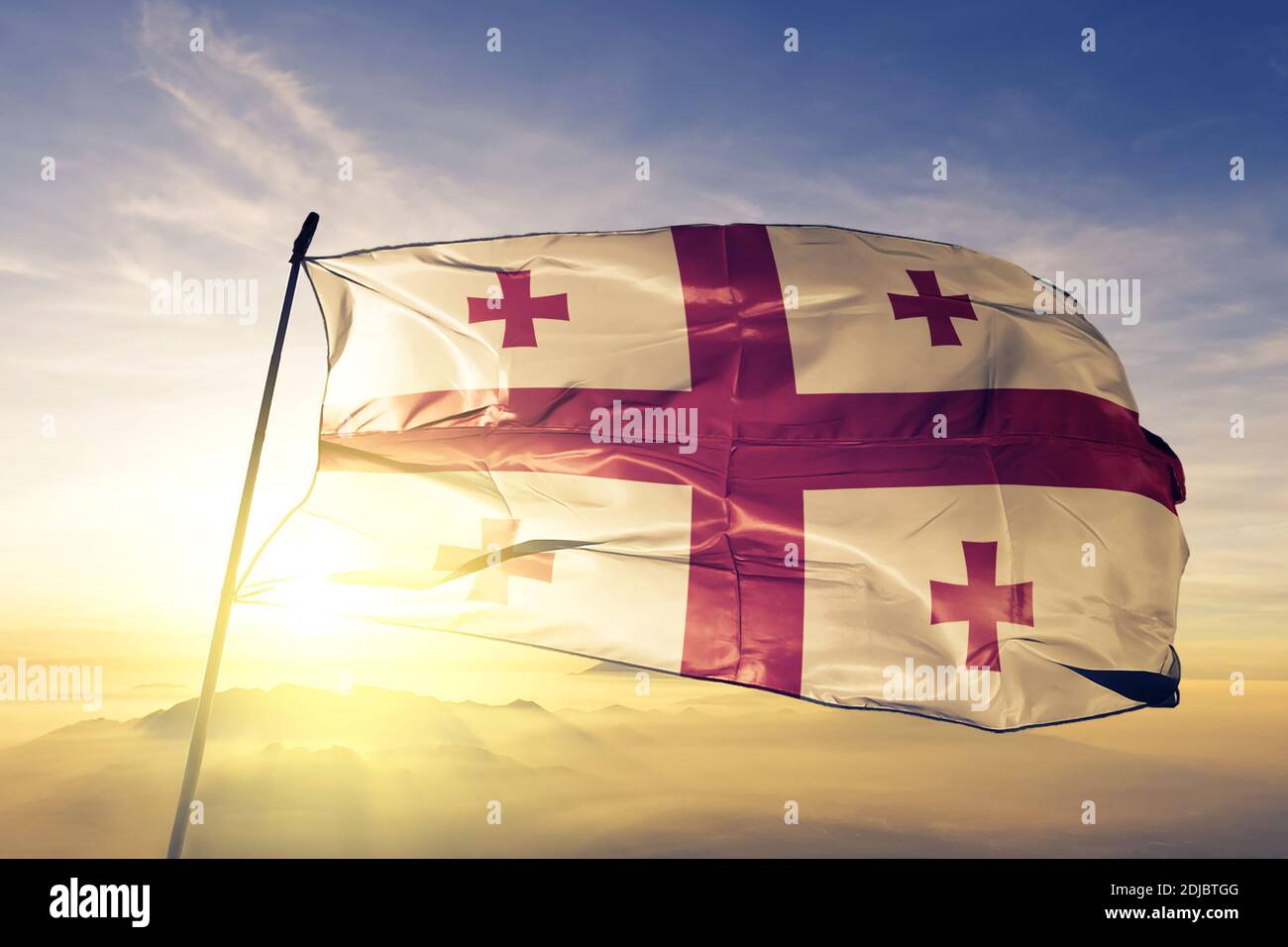 Georgia flag waving on the top sunrise mist fog Stock Photo - Alamy