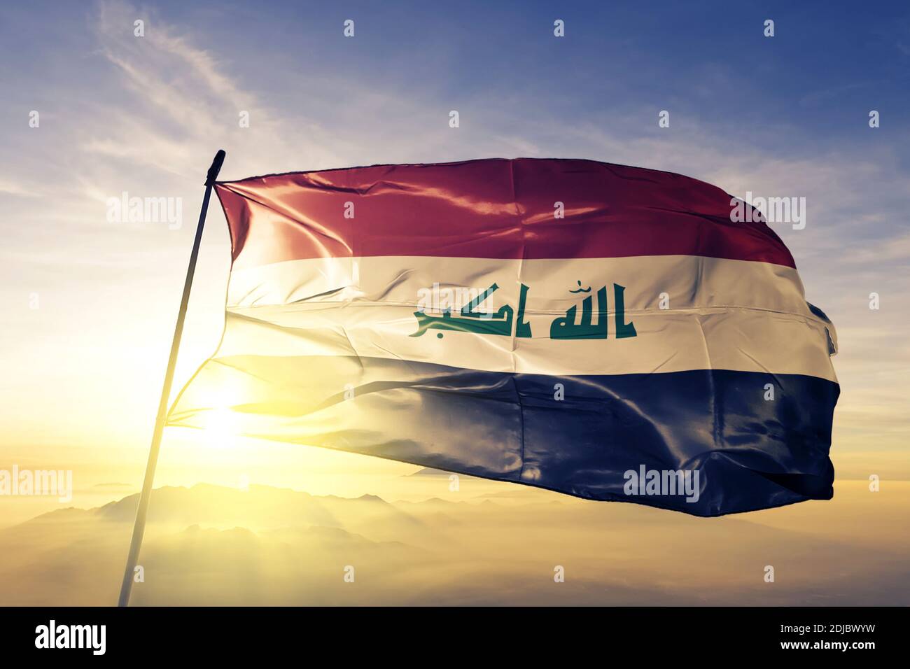 Iraq flag waving on the top sunrise mist fog Stock Photo - Alamy