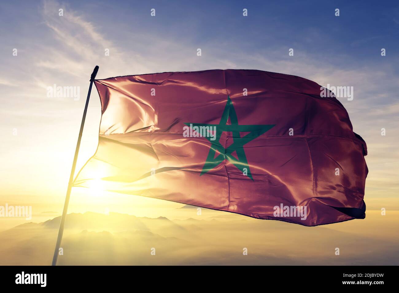 Morocco flag waving on the top sunrise mist fog Stock Photo - Alamy