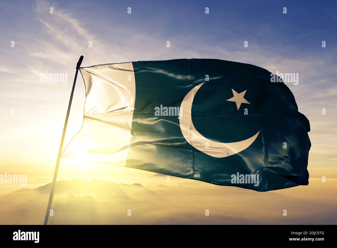 Pakistan flag waving on the top sunrise mist fog Stock Photo - Alamy