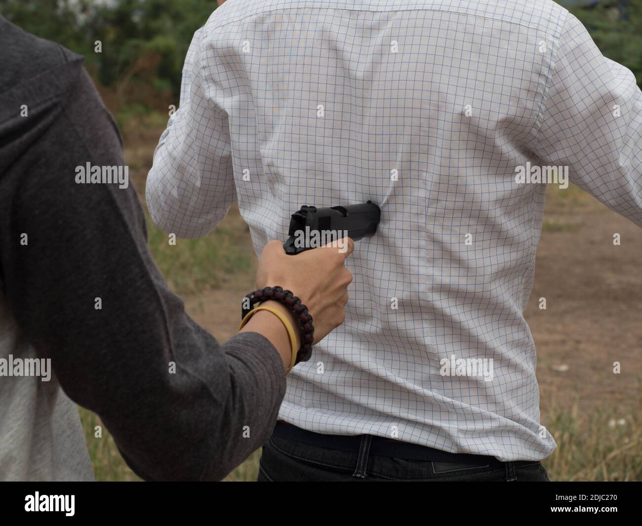 Man aiming handgun rear view hi-res stock photography and images - Alamy