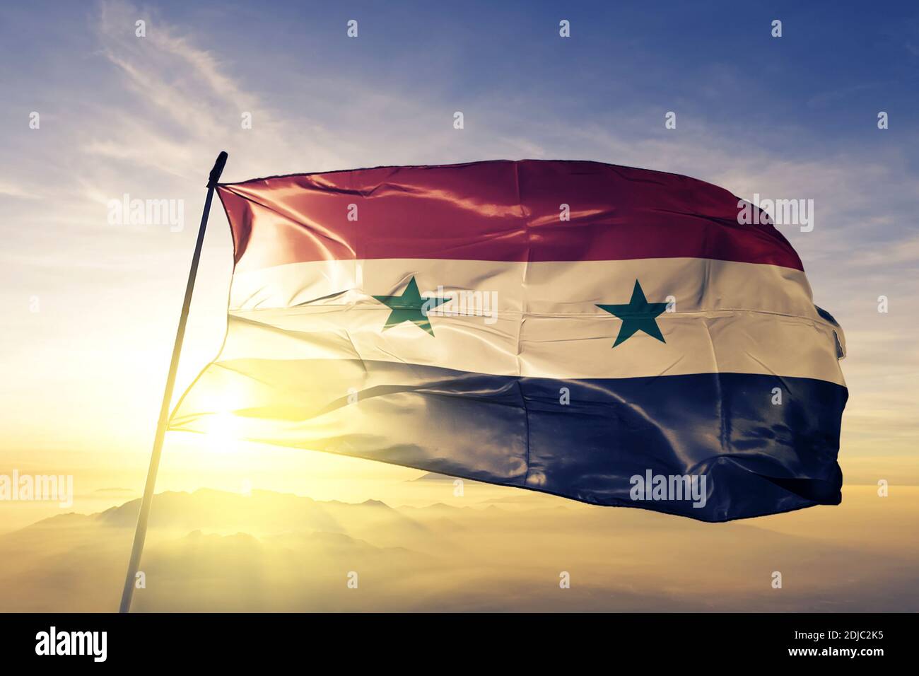 Syria flag waving on the top sunrise mist fog Stock Photo - Alamy