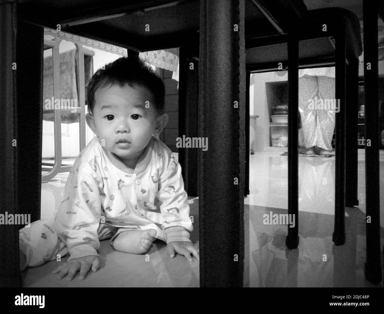 Boy under table Black and White Stock Photos & Images - Alamy