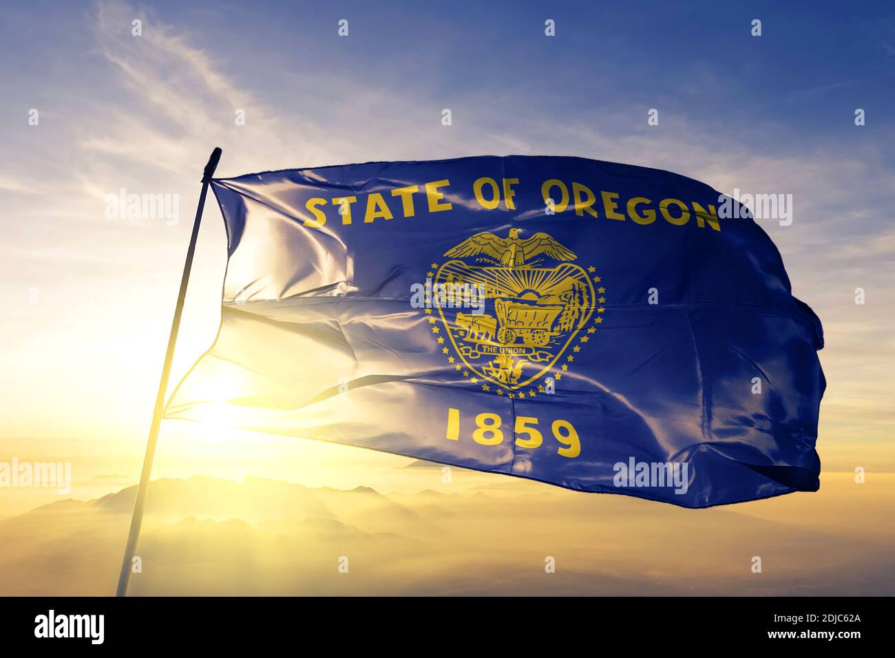 Oregon state of United States flag waving on the top sunrise mist fog ...