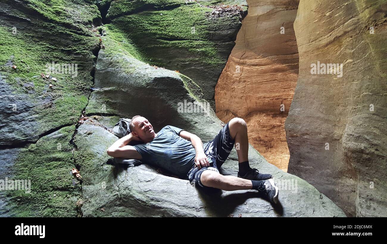 Man lying down in cave hi-res stock photography and images - Alamy