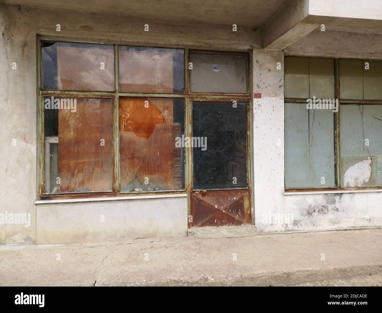 The remaining of a shop with rusty windows and broken windows Stock ...