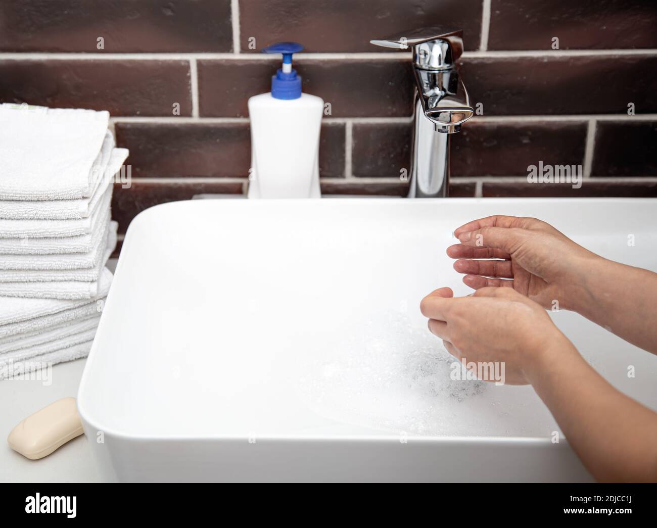 Washing hands with running water in the bathroom. The concept of ...
