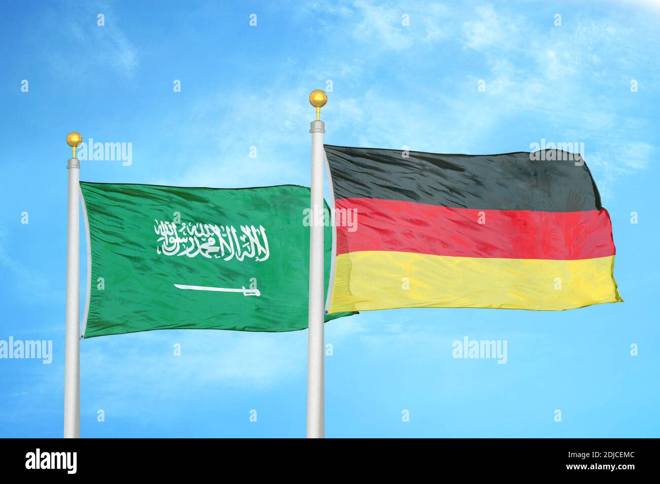 Saudi Arabia and Germany two flags on flagpoles and blue cloudy sky ...