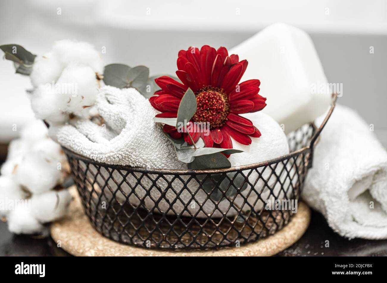 Bath towel and bath bomb and red flower. Hygiene and health concept ...