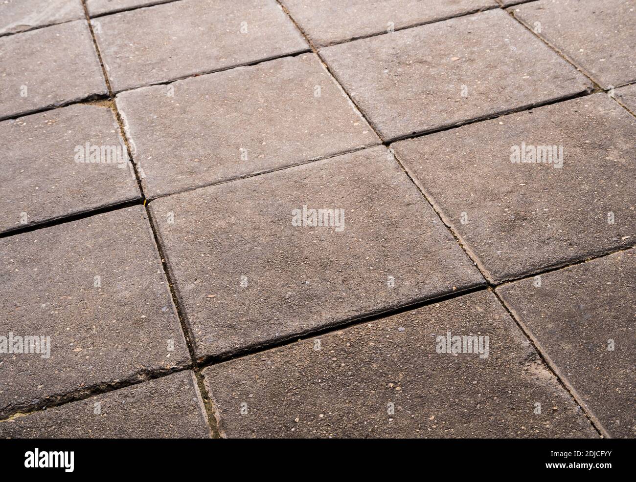 The road side pathway is paved with square blocks of concrete Stock ...