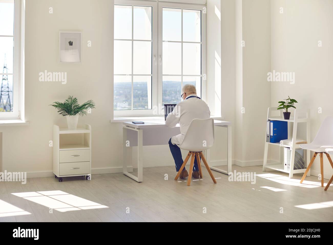 Rear view old doctor working hi-res stock photography and images - Alamy