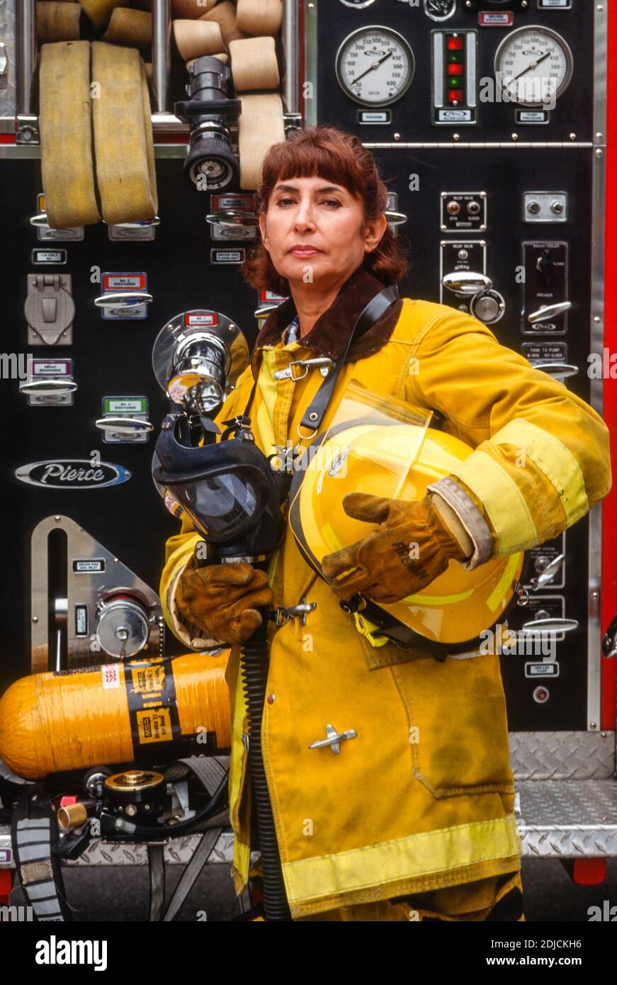 Female Hispanic Firefighter Poses in front of a Fire Truck, California ...