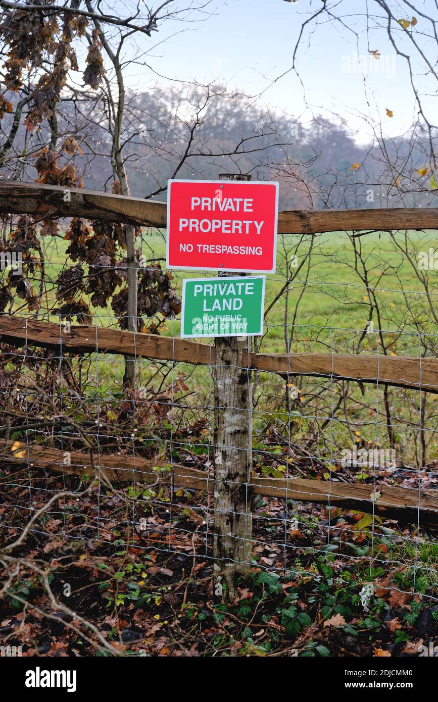 Two signs on a countryside fence informing the public of 'Private Land ...