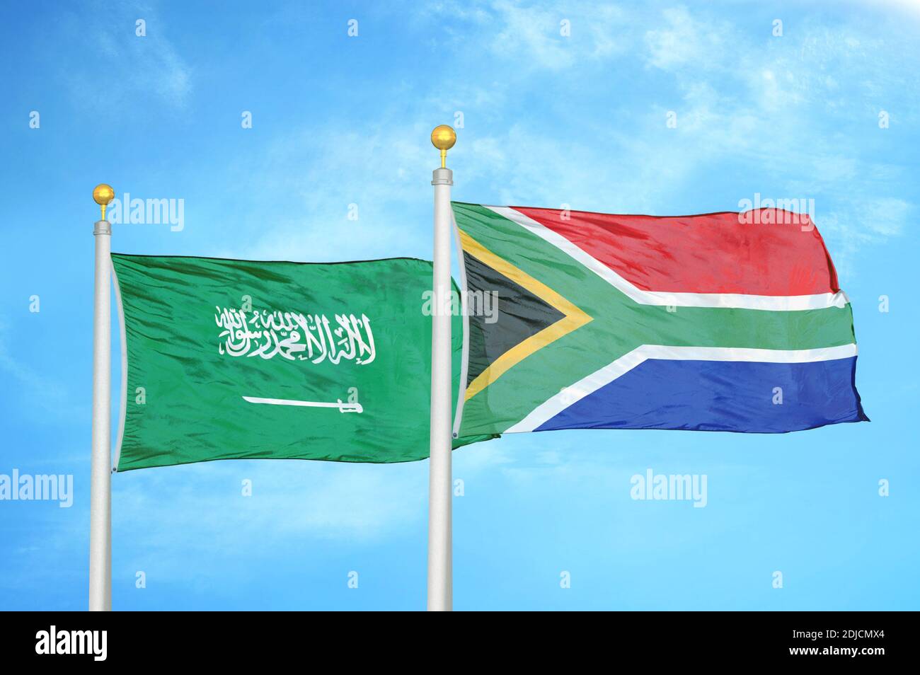 Saudi Arabia and South Africa two flags on flagpoles and blue cloudy ...