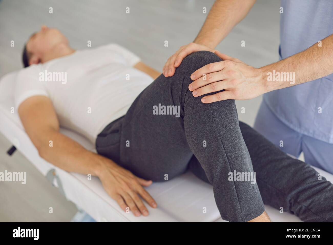 Hands of professional man chiropractor manual therapist fixing lying ...