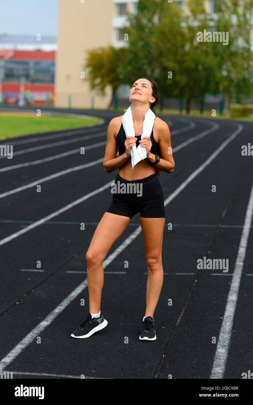 Athlete runner running on athletic track training her cardio. Woman ...