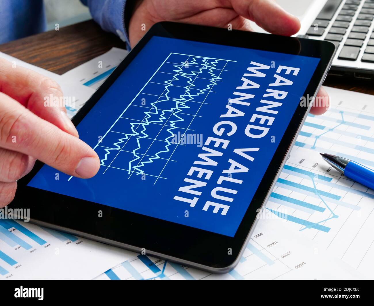 Manager reads Earned Value Management EVM report Stock Photo - Alamy