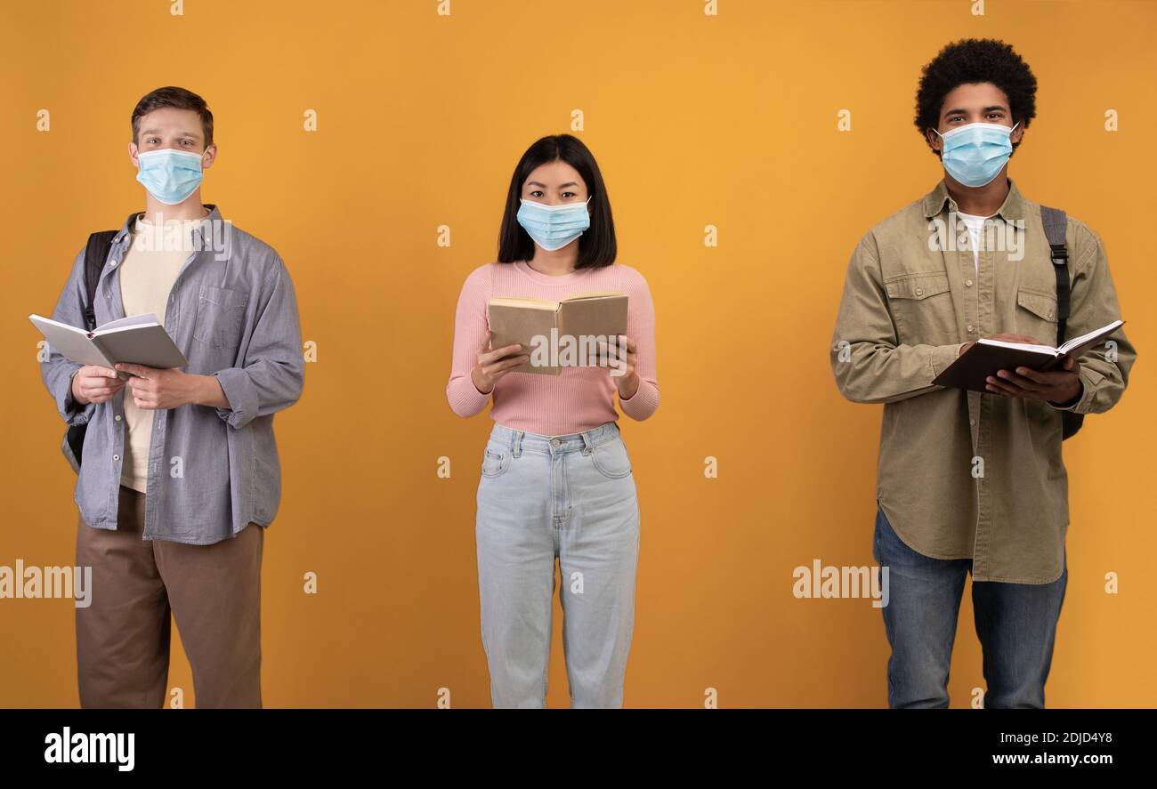 New normal, education and covid-19 pandemic. Young students read books ...