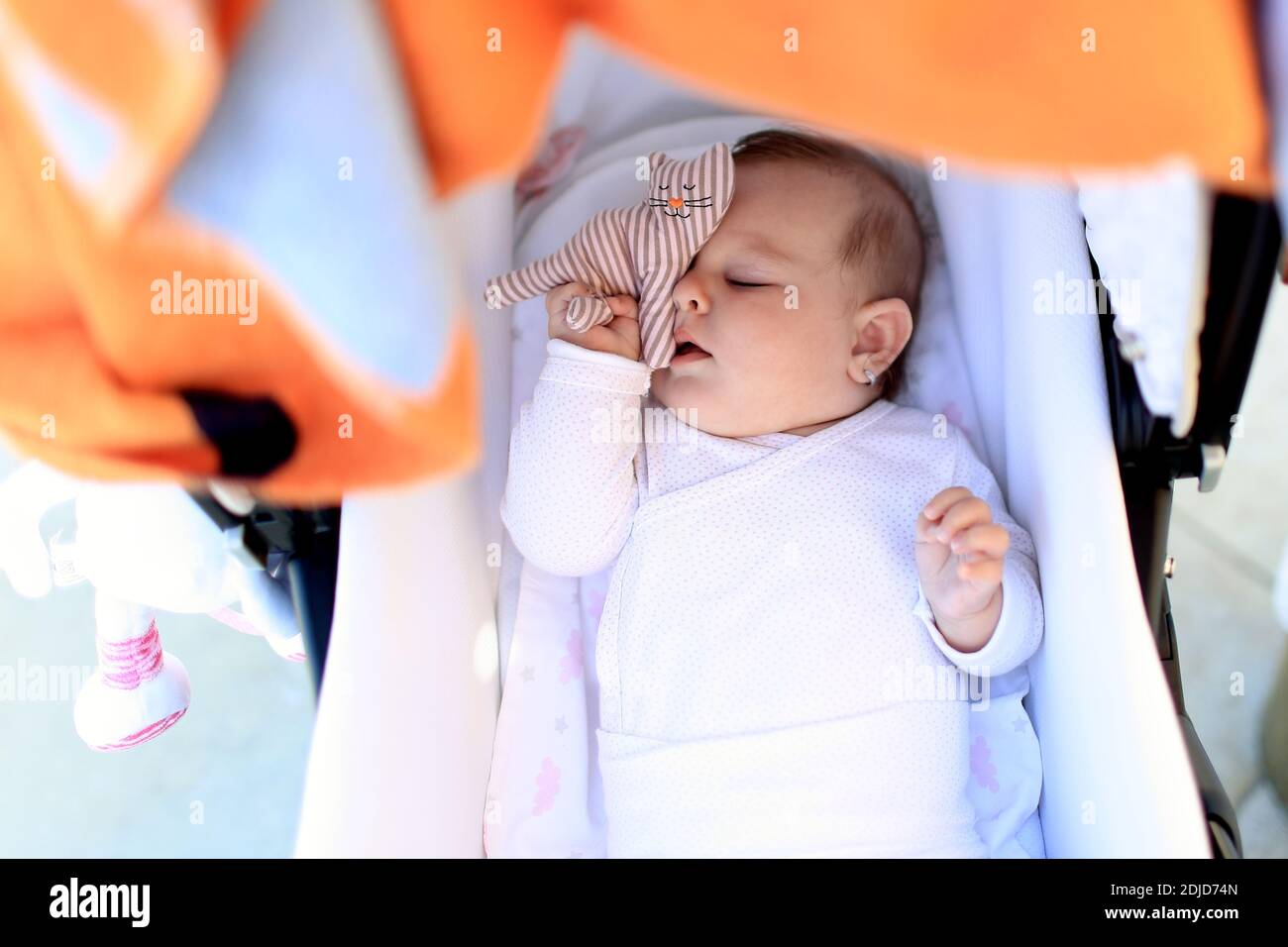 Baby girl sleeping in stroller hi-res stock photography and images - Alamy