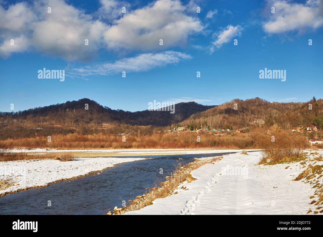Calm winter mountain river, on a clear sunny day, against the ...