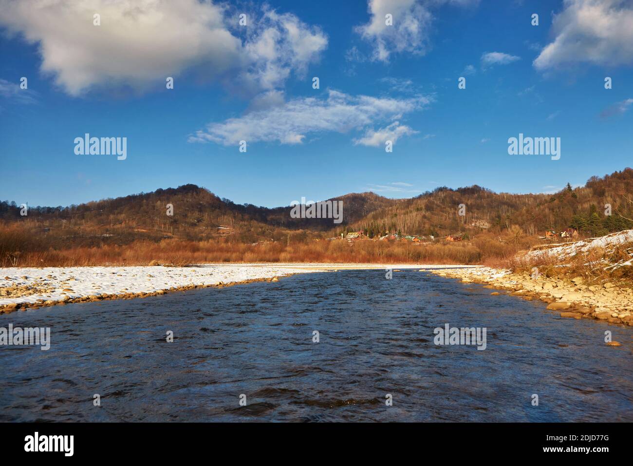 Calm winter mountain river, on a clear sunny day, against the ...