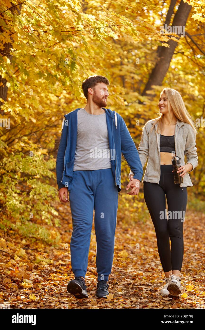 happy lovely couple enjoying walk in the forest, have talk after ...