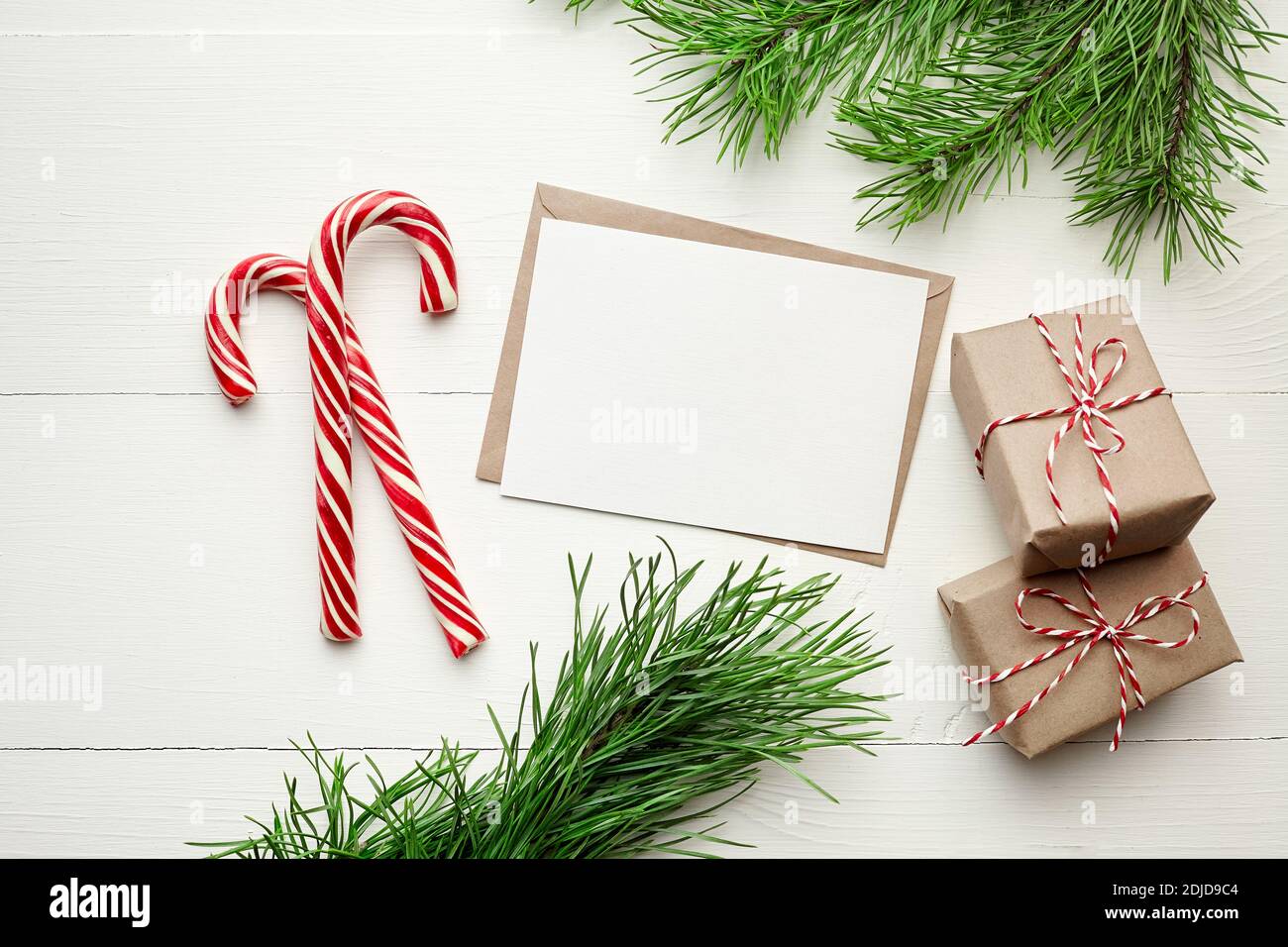 Christmas card mockup with gift boxes, candy canes and pine tree ...