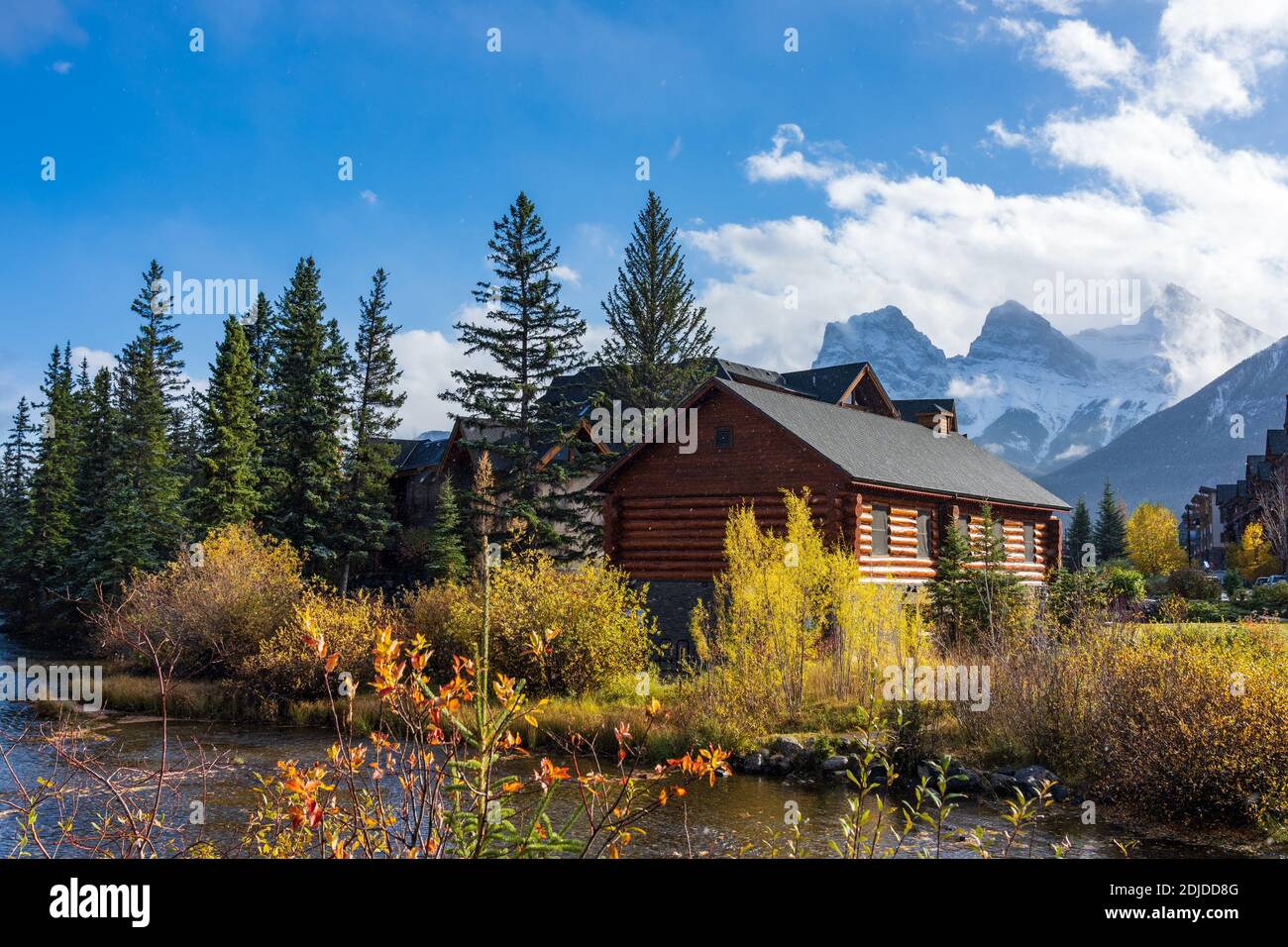 Canmore Opera House and Spring creek, clear blue sky snow capped The ...