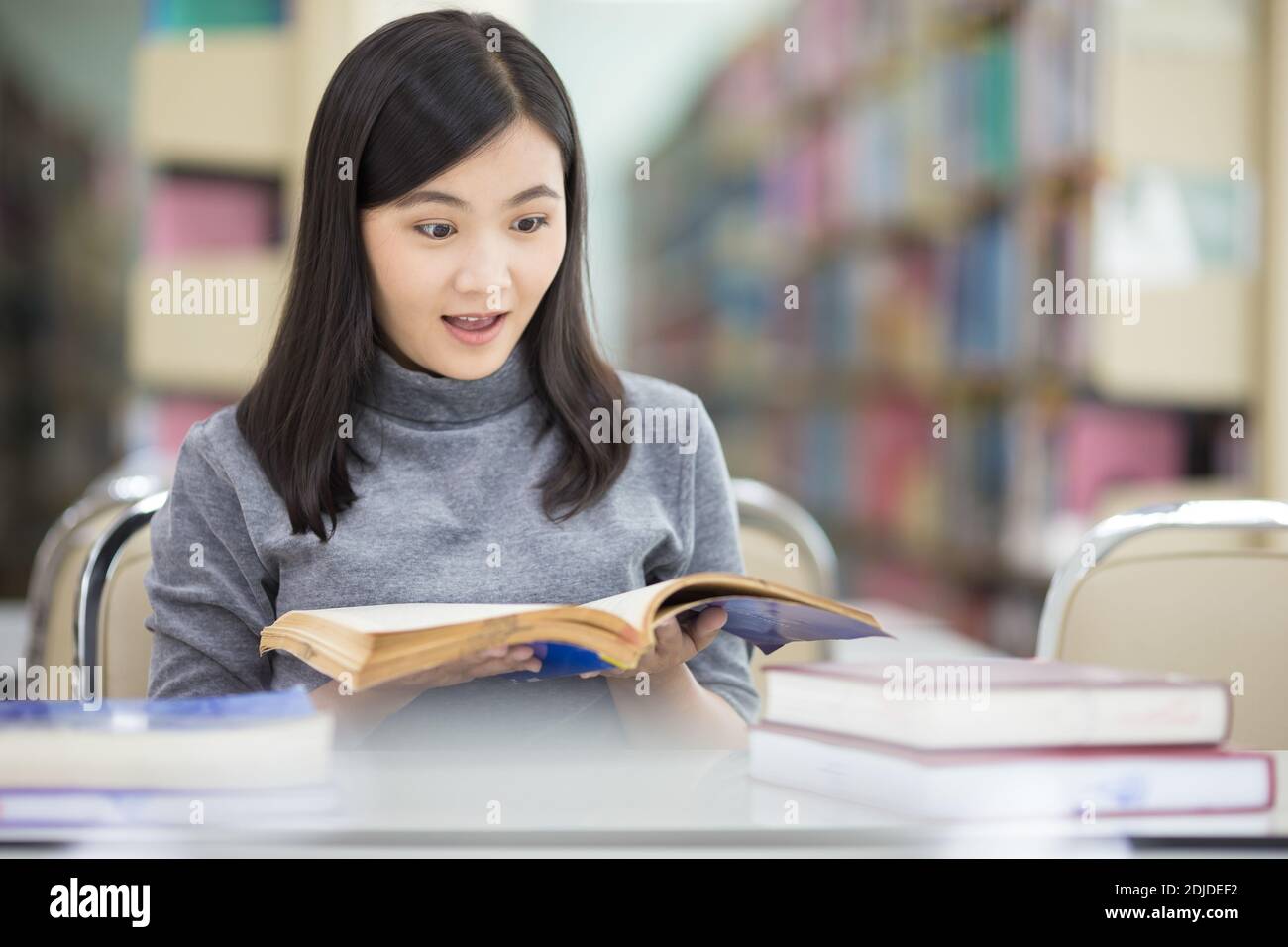 Woman shock reading book library hi-res stock photography and images ...