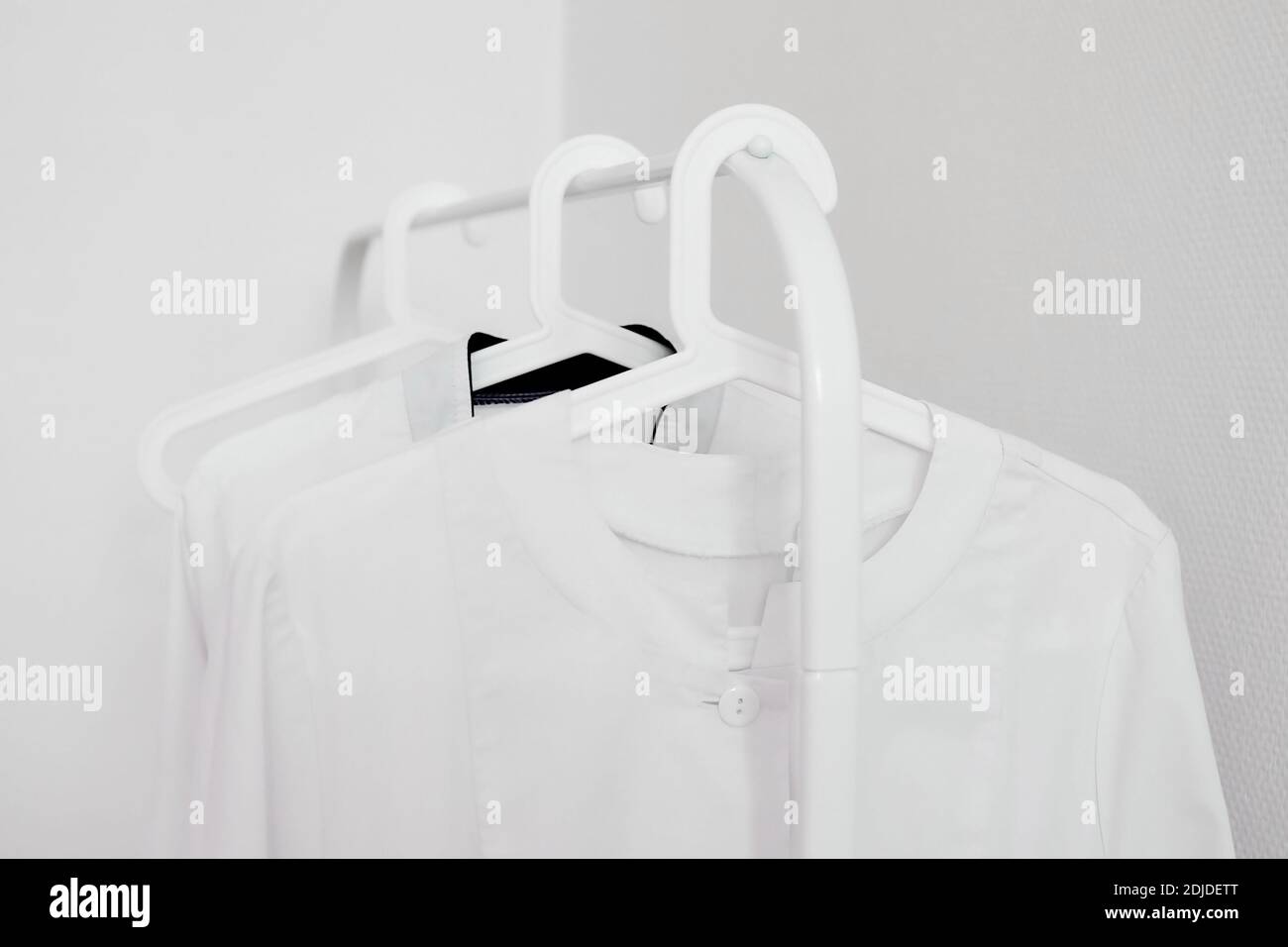Coat hanger with white medical gown. Clothing. Doctor's Wardrobe Stock ...