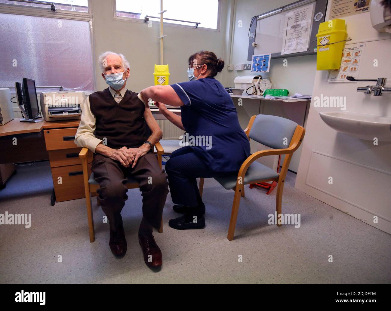 Brian Horne receives the first of two injections with a dose of the ...